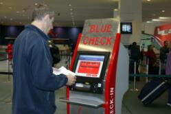 A passenger using Virgin Blue's self service check-in "Blue Check ...